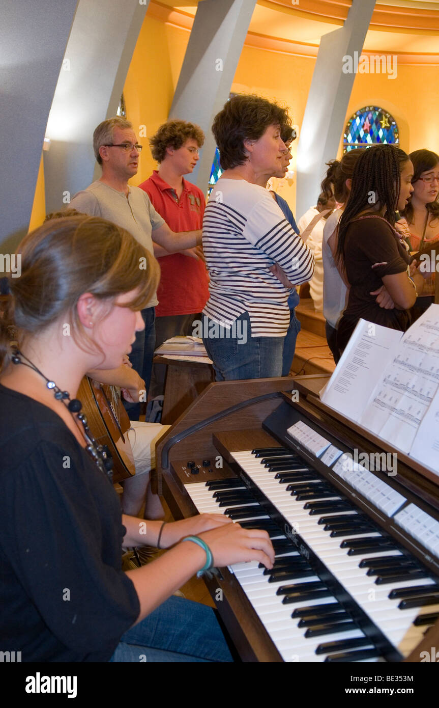 Keyboard player and group of young people singing in church Stock Photo ...
