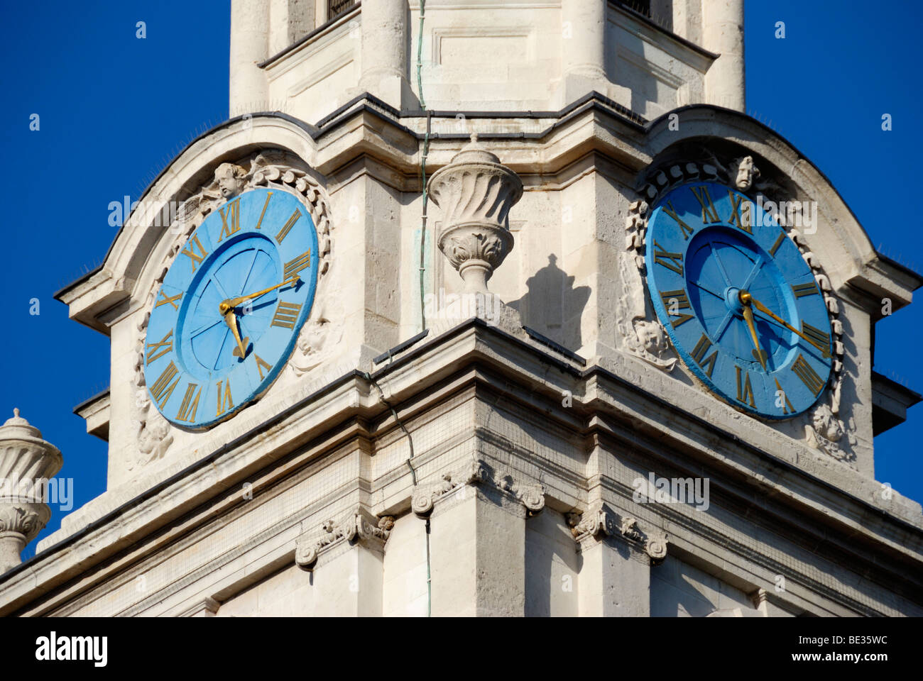 Two clocks on a church tower Stock Photo - Alamy