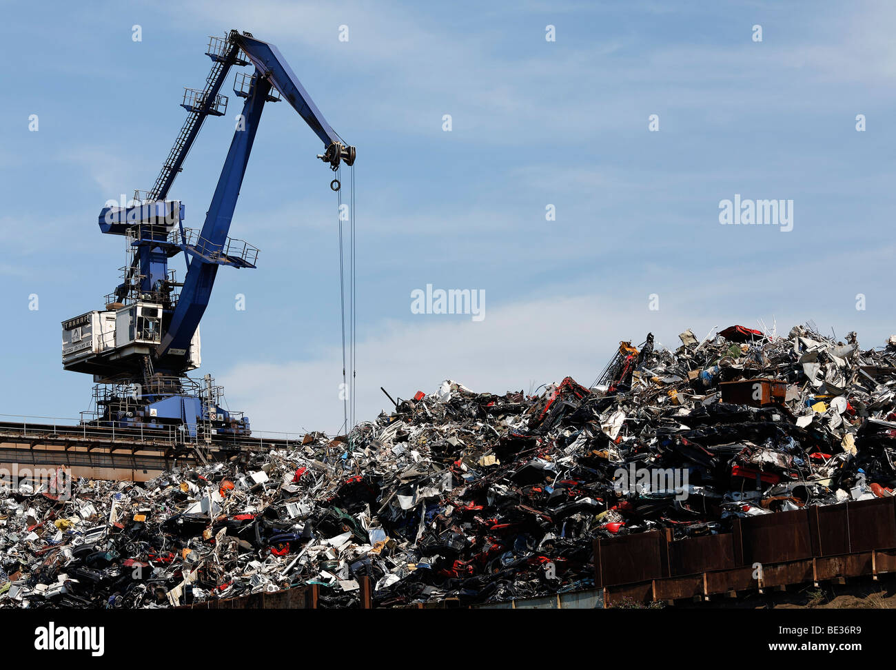 Large overhead crane handling scrap metal for recycling, scrap island ...