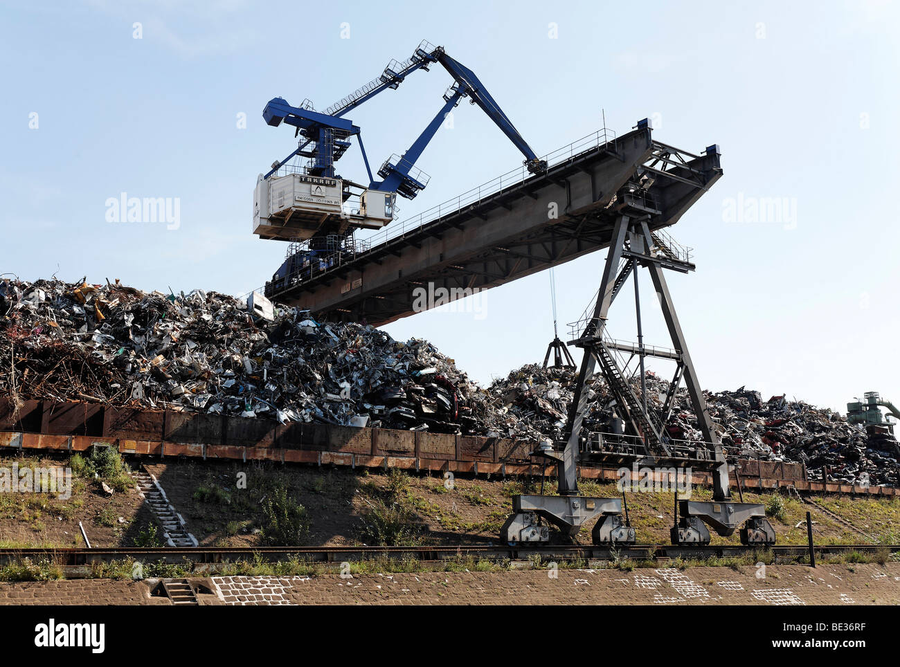 Large overhead crane handling scrap metal for recycling, scrap island ...