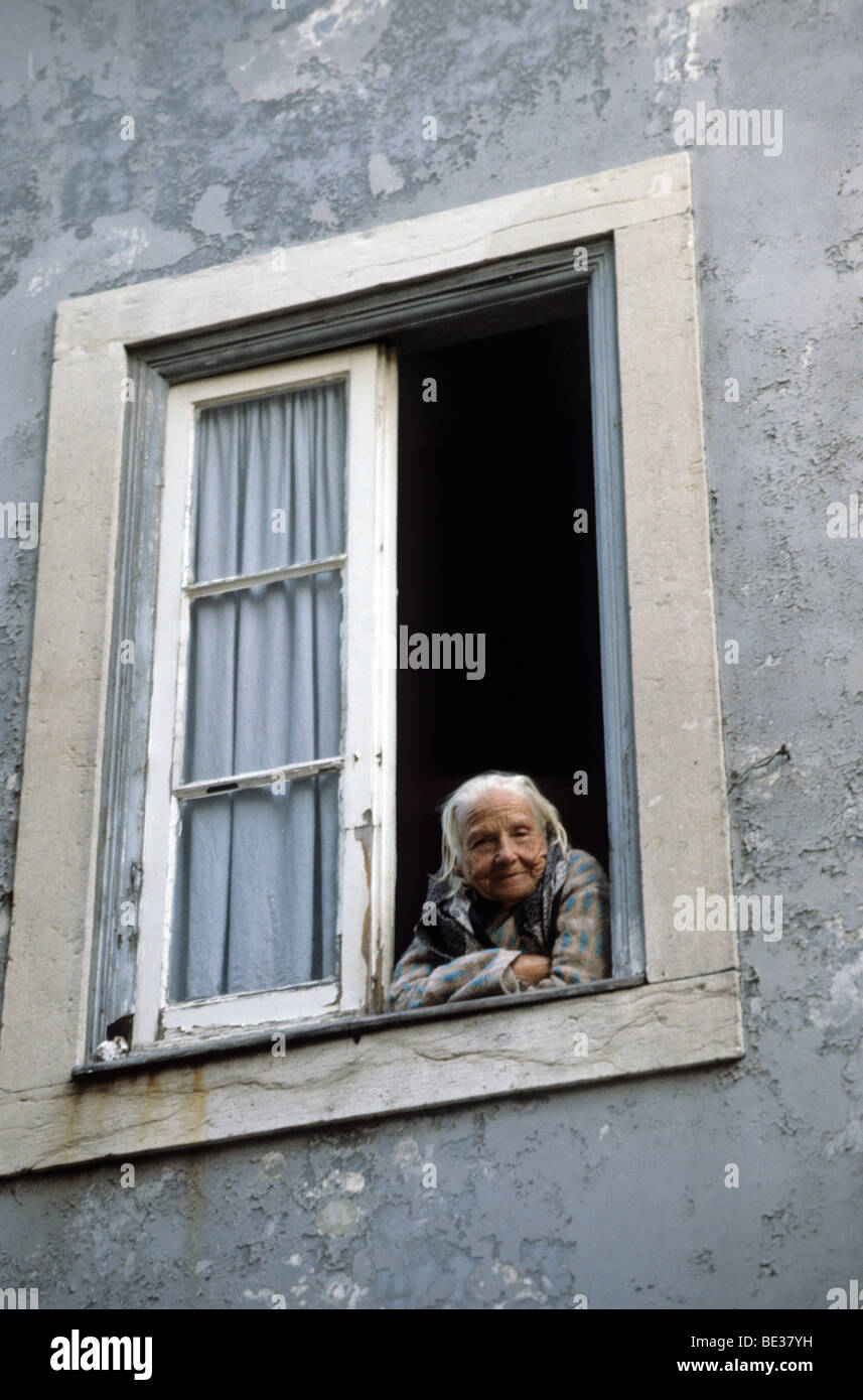 Elderly woman looks out window hi-res stock photography and images - Alamy