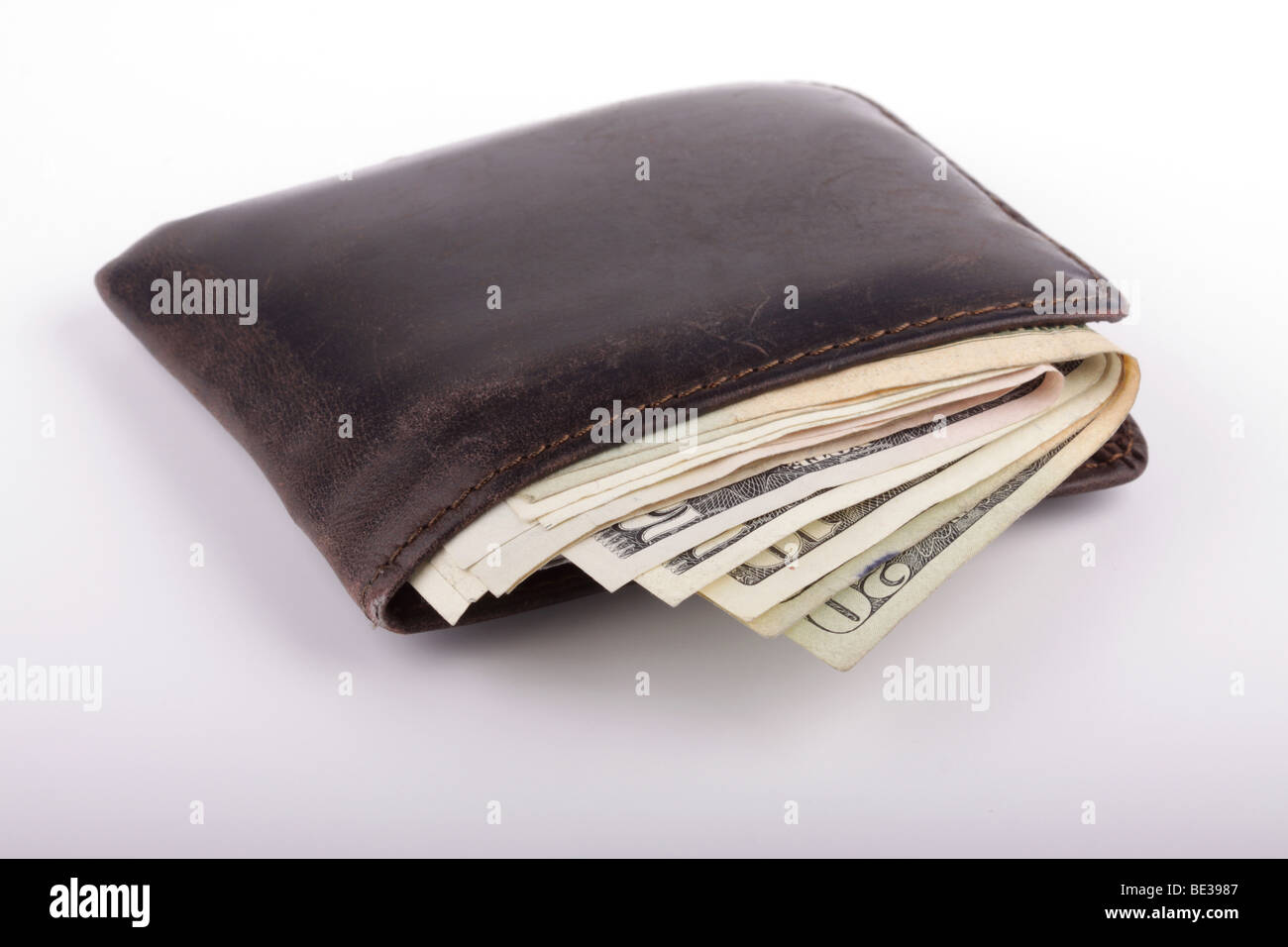 Old pocket wallet worn out and full of money Stock Photo - Alamy