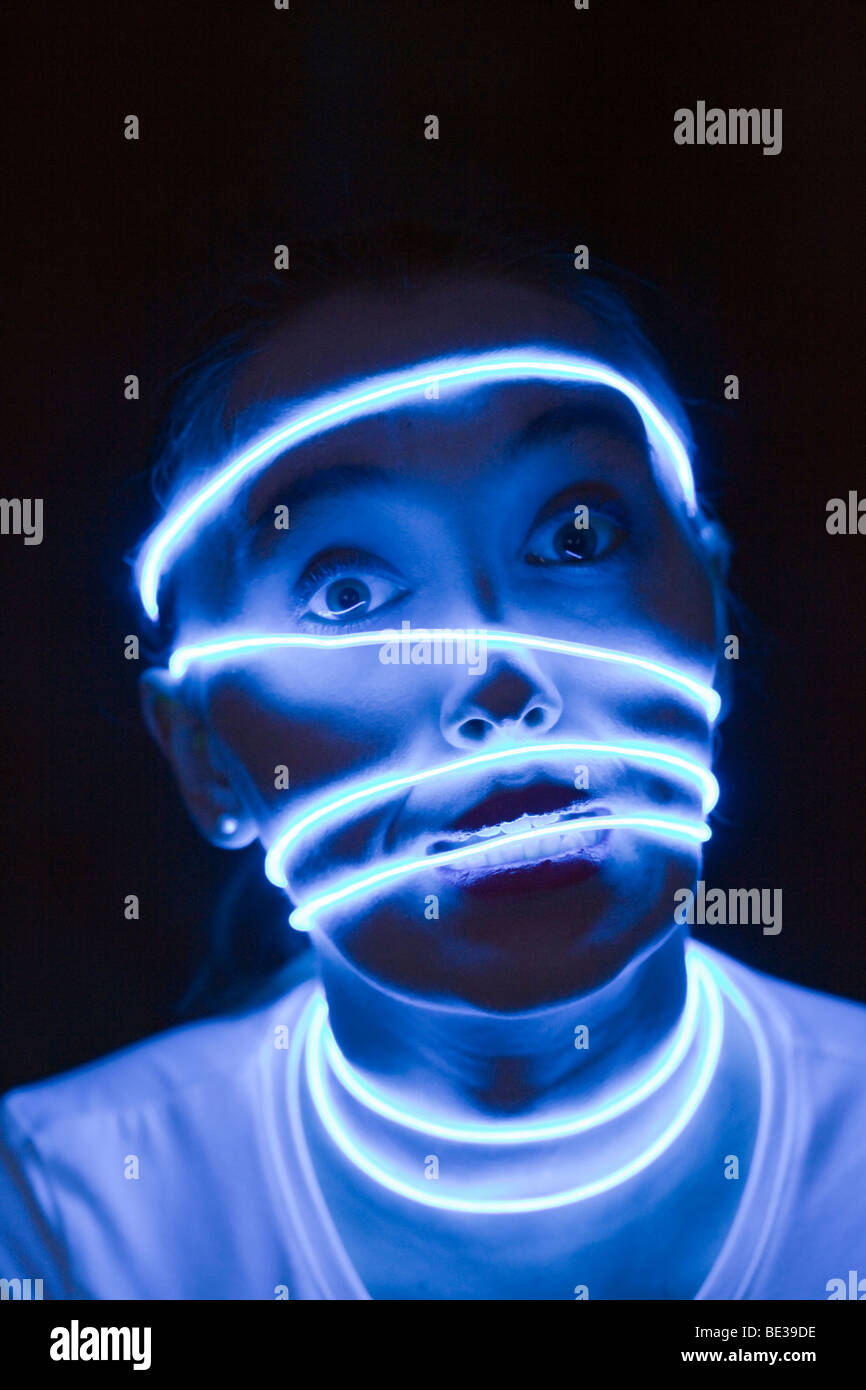 Portrait of young woman wrapped in el-wire Stock Photo - Alamy
