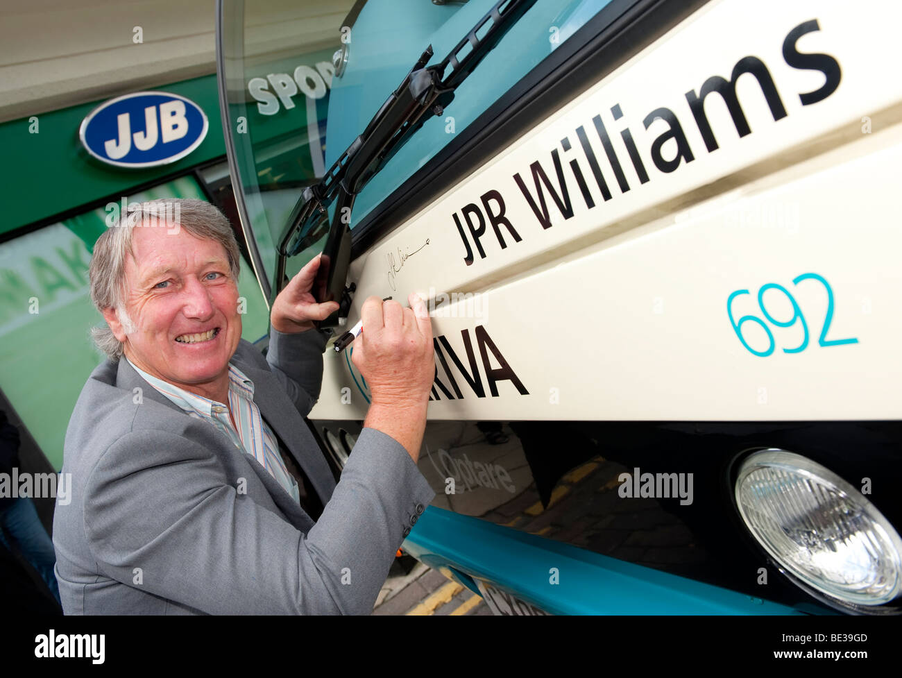 Welsh rugby legend, JPR Williams signs his autograph on a bus bearing ...