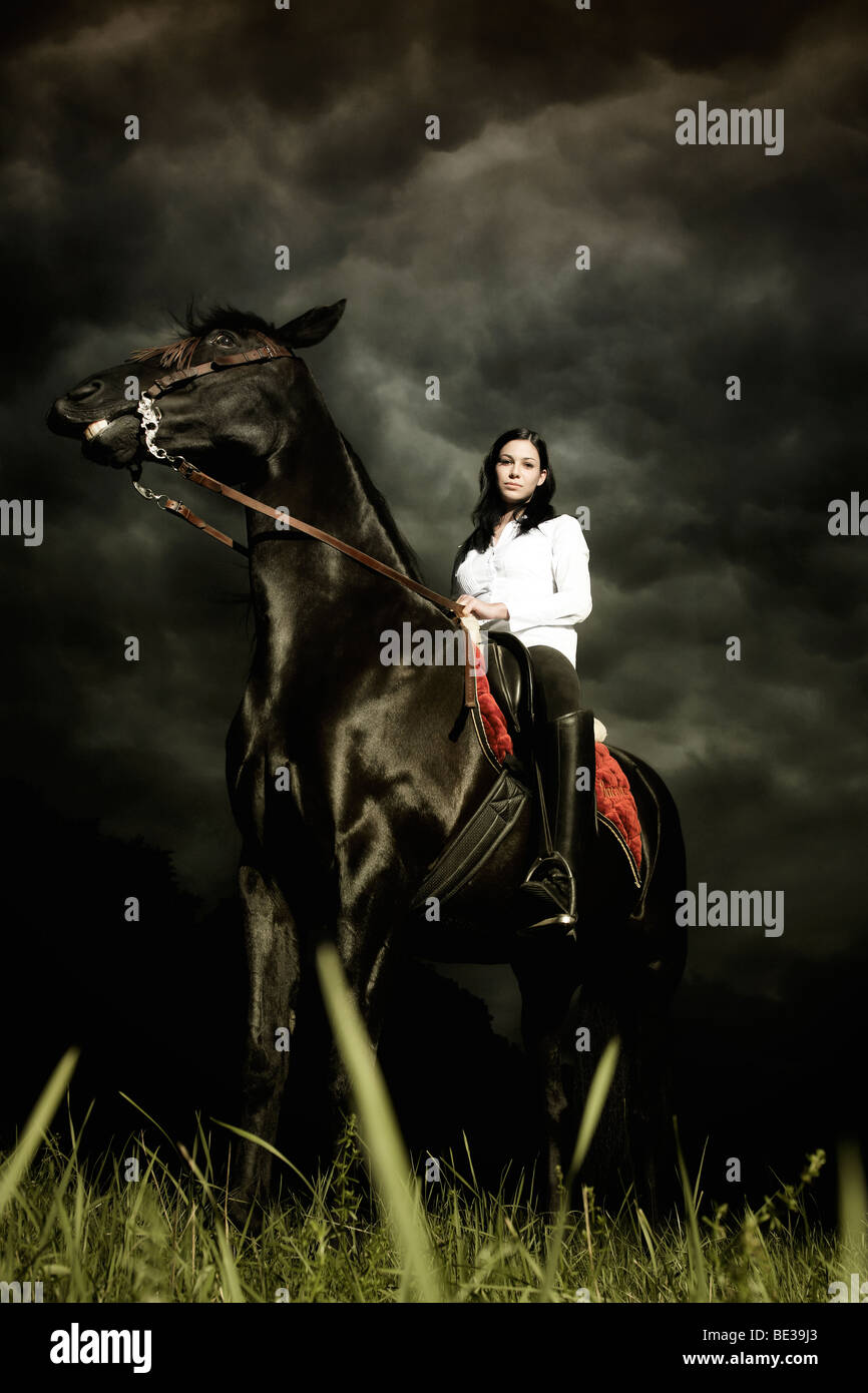 Young woman riding her horse Stock Photo - Alamy