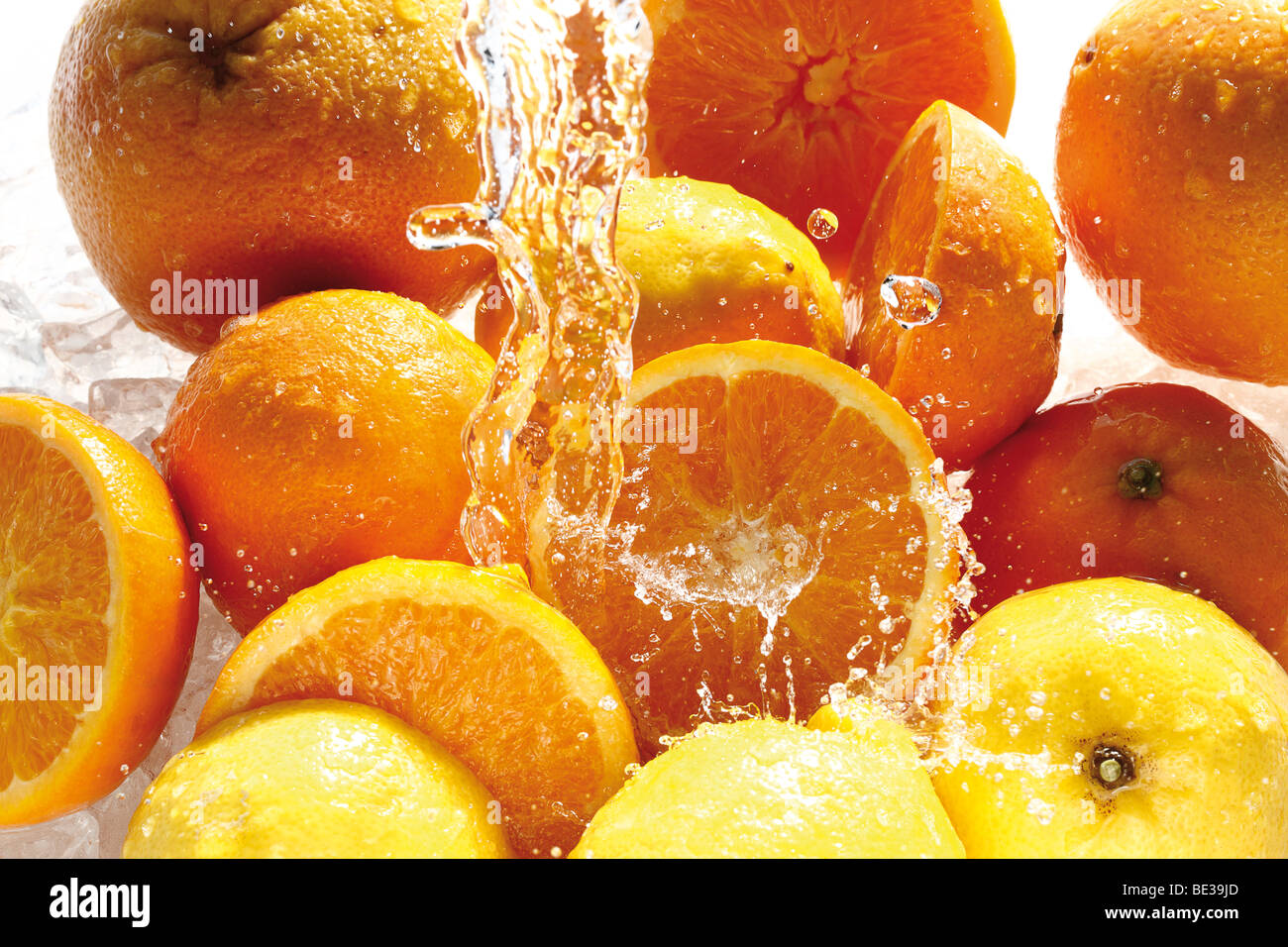 Citrus fruit with jet of water Stock Photo - Alamy