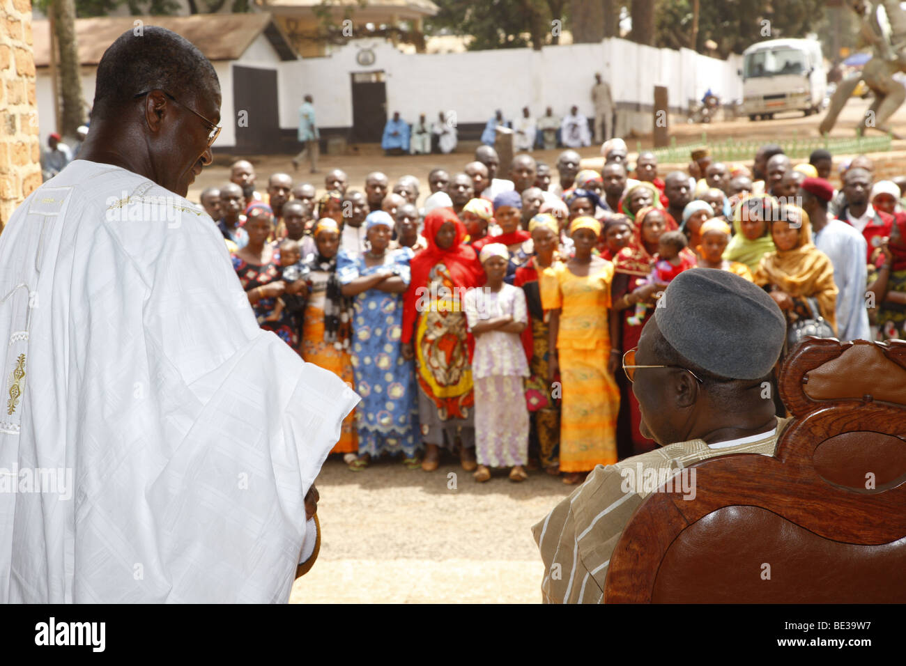 Sultan Ibrahim Mbombo Njoya in front of the Sultan's palace, holding an ...