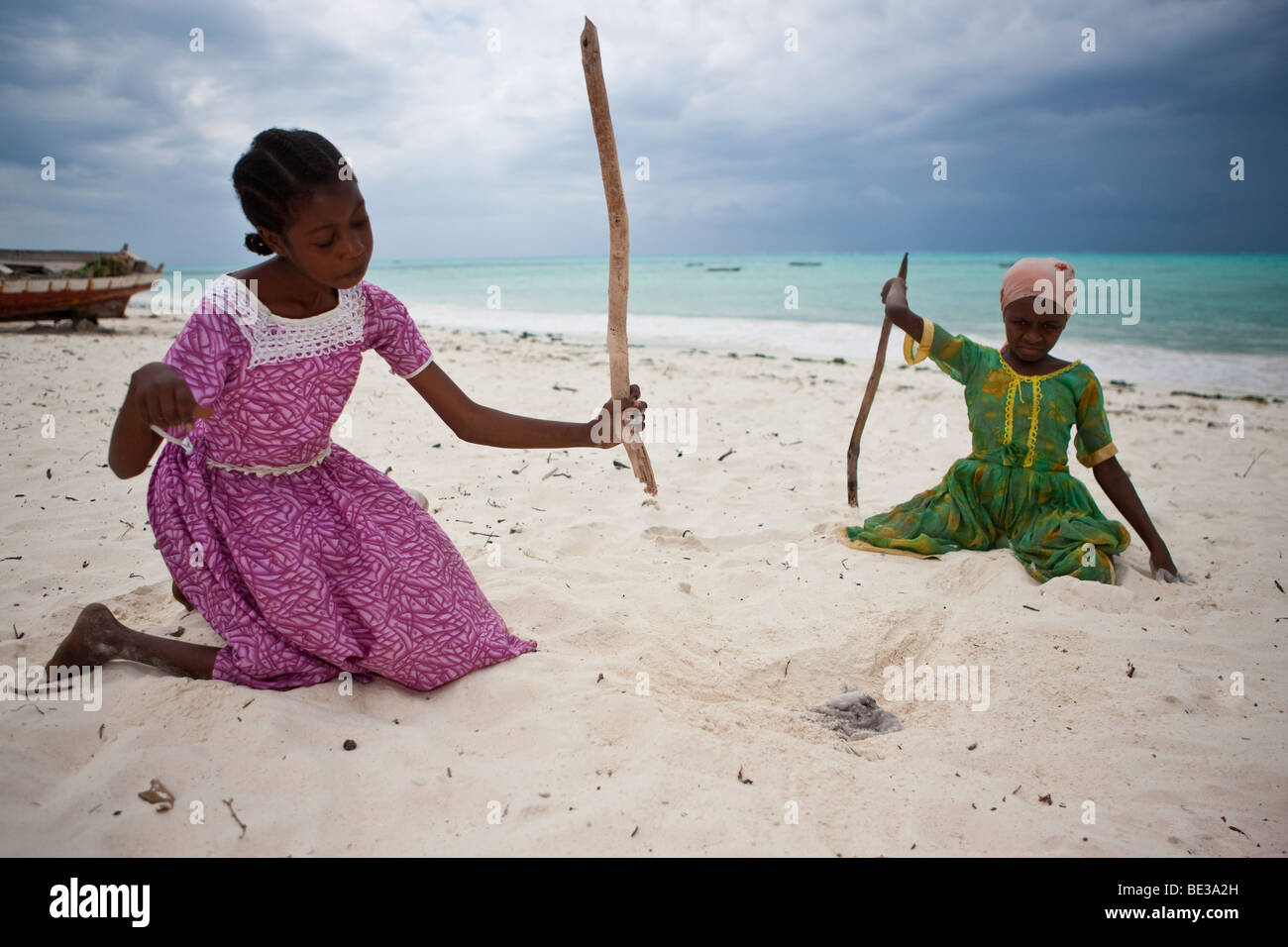 Children beating an octopus with sticks in order to make it edible ...