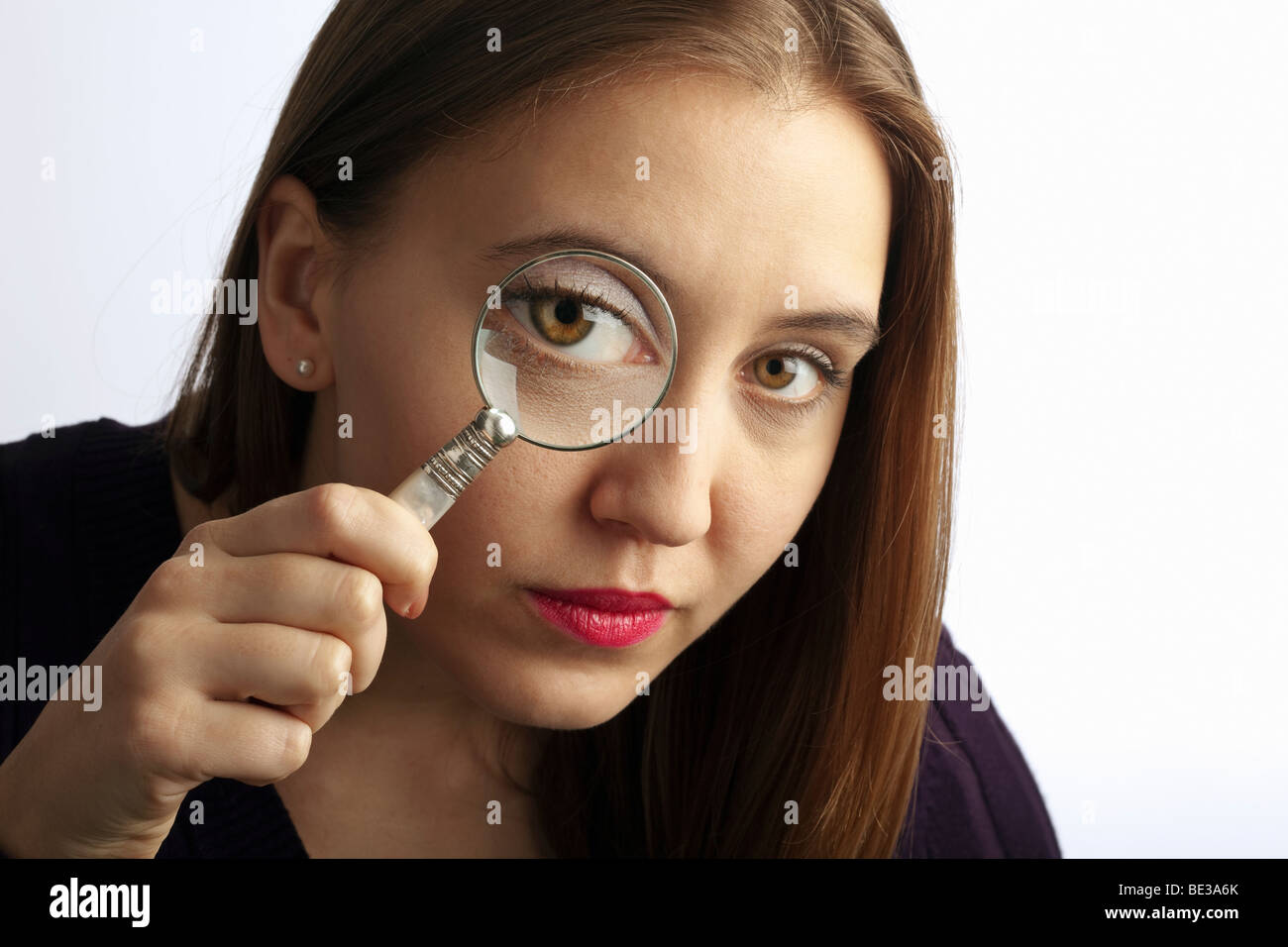 Woman with magnifying glass Stock Photo - Alamy