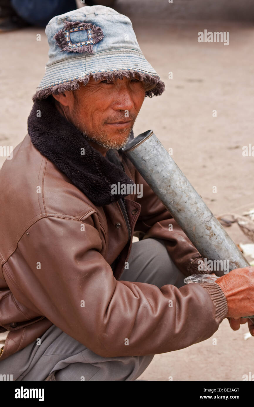 Han Chinese man using the traditional waterpipe in Yunnan, China Stock ...