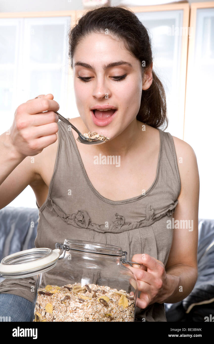 Girl eating from a muesli glass Stock Photo - Alamy
