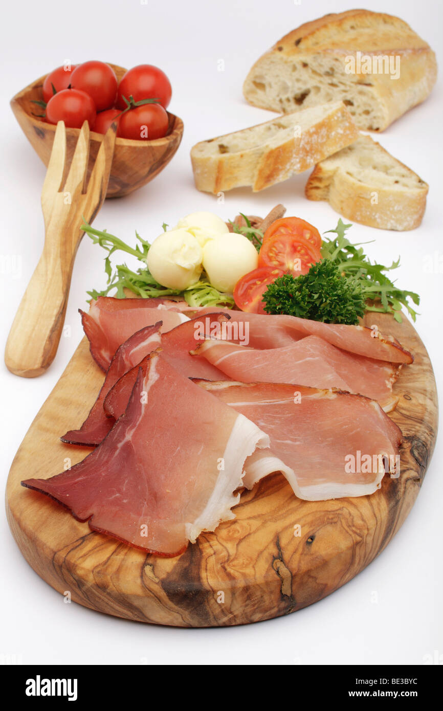 Raw ham with butter, tomatoes, olives and Italian white bread Stock ...