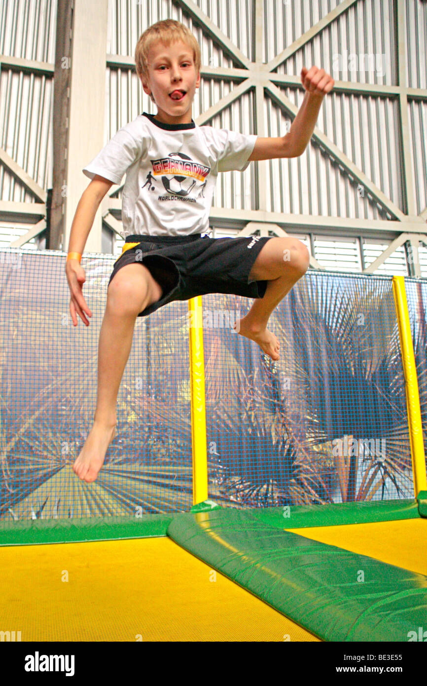 young boy jumping jauntily on a trampoline Stock Photo - Alamy