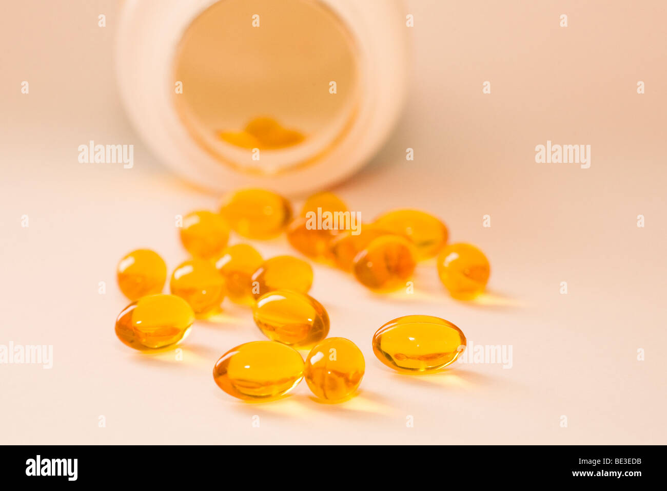 Vitamin tablets spilling from bottle Stock Photo - Alamy