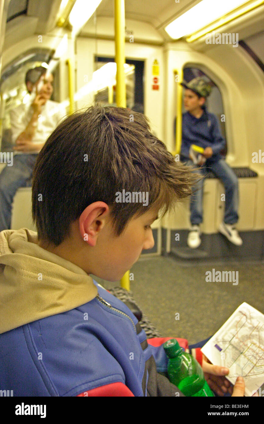 three young boys traveling by Underground Train in London Stock Photo ...