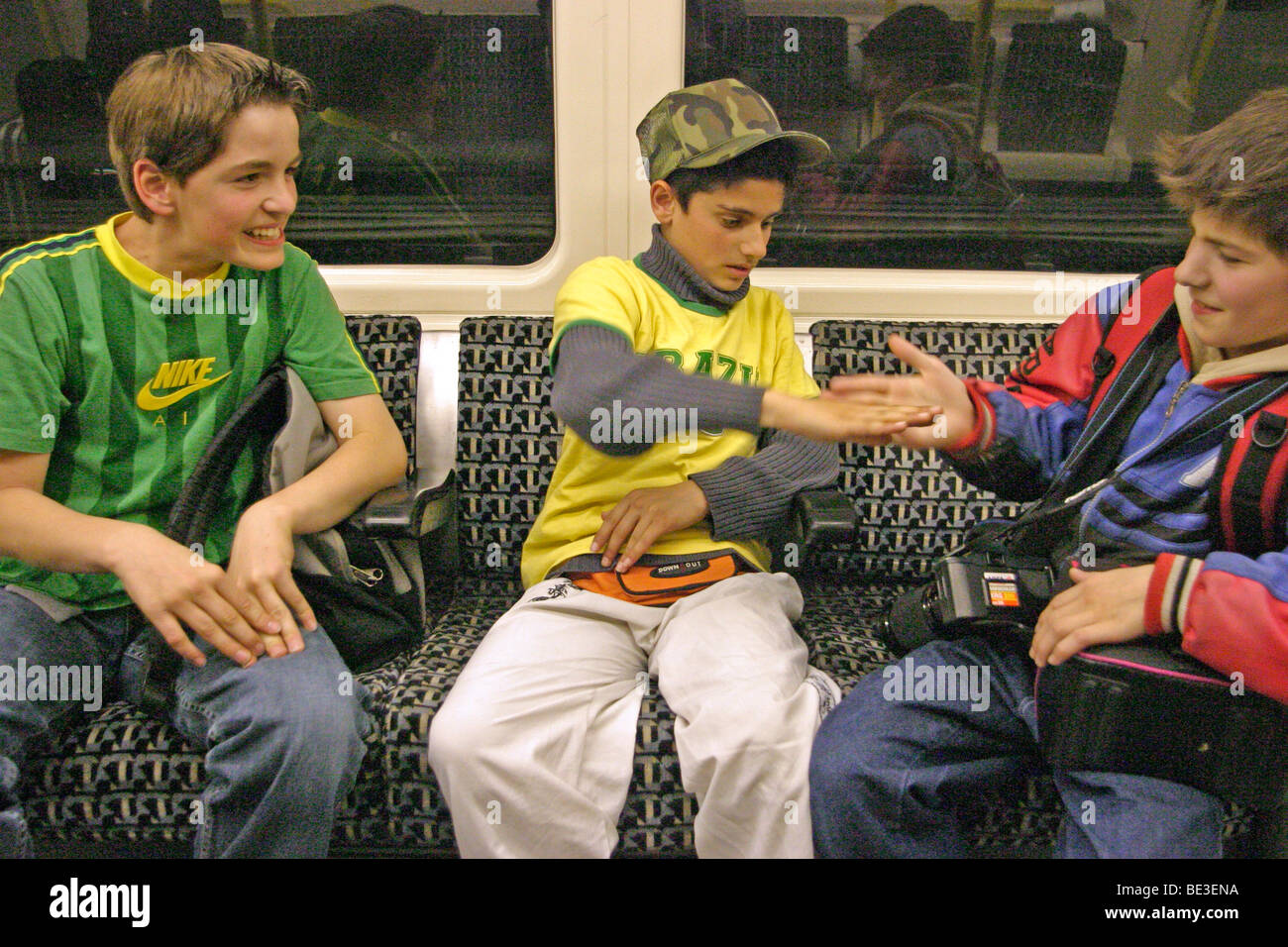 three young boys traveling by Underground Train in London Stock Photo ...