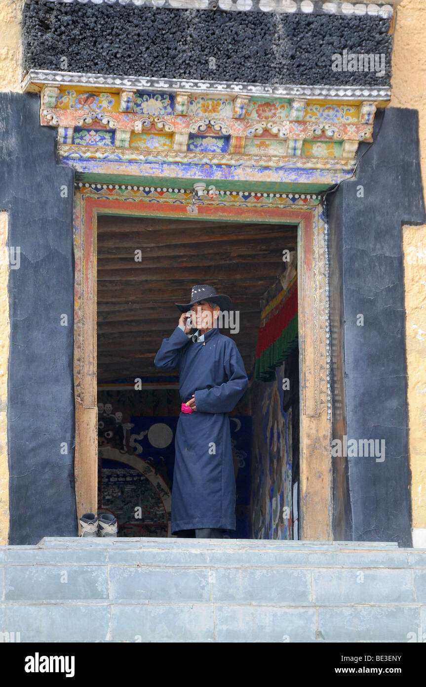 Thikse Monastery, Ladakhi wearing traditional coat, Goncha, using a ...