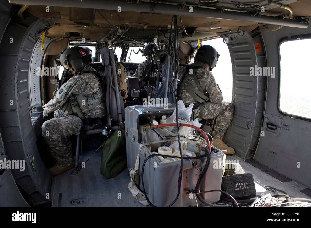 U.S. Army soldiers watch for hazards during a flight to provide air ...