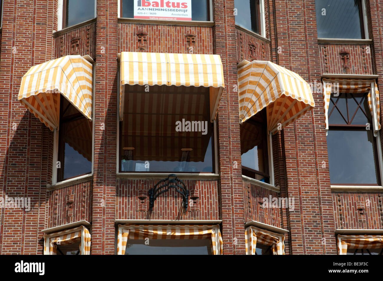 Windows with awnings in a Dutch building. Amsterdam, Holland Stock ...