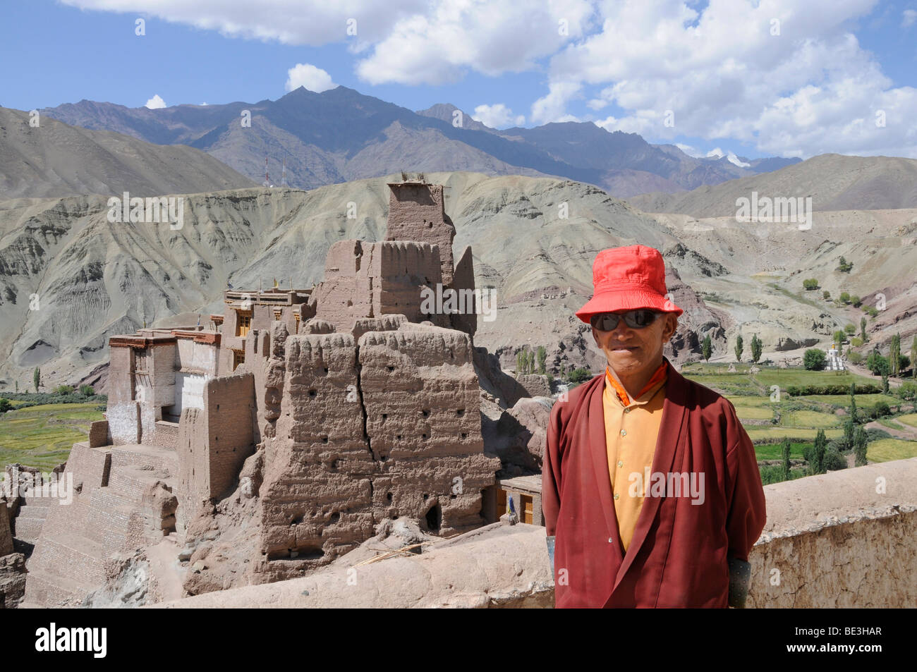 Buddhist monk in front of the Basgo castle ruins and monastery in the ...