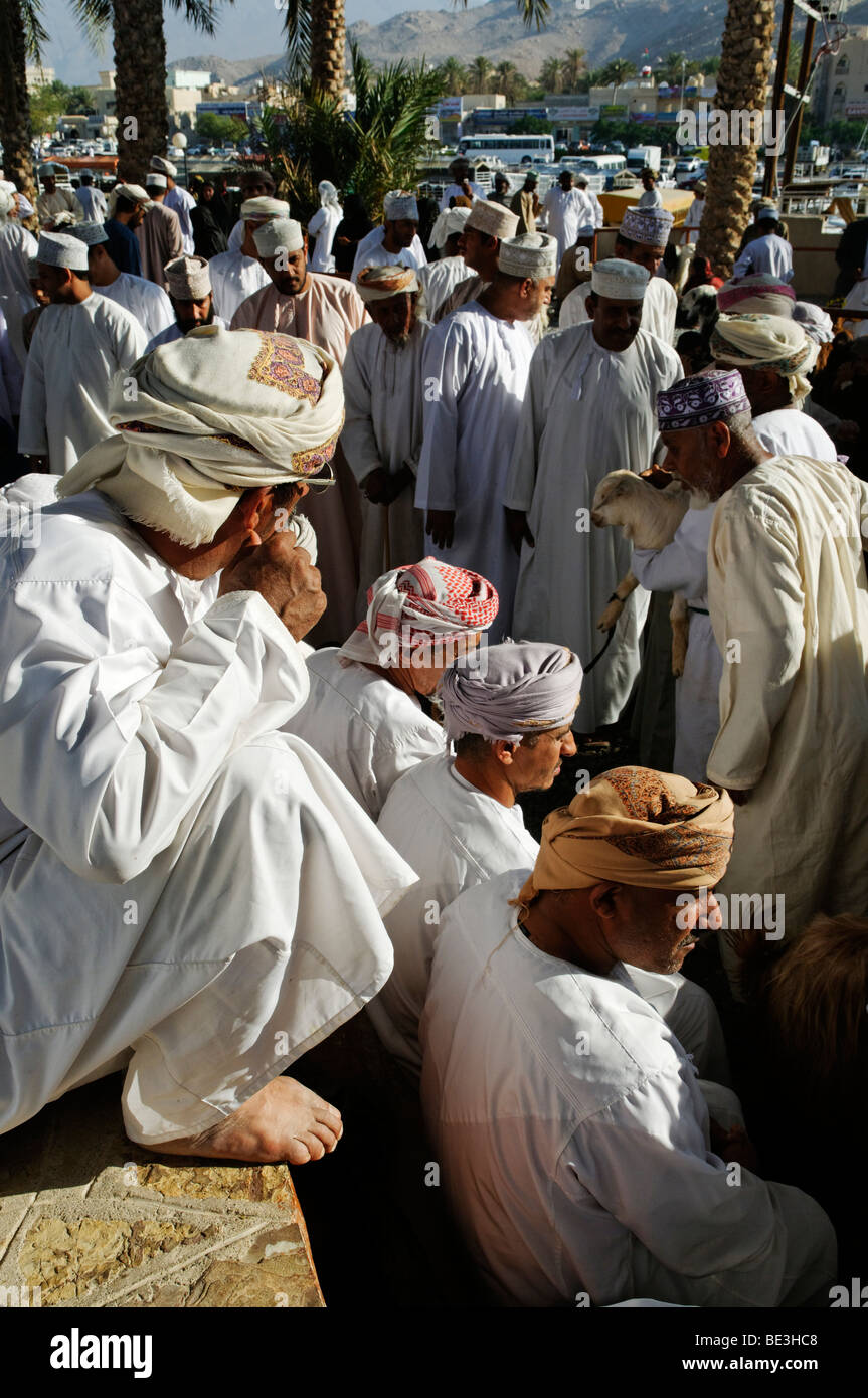 Omani men in traditional dress, livestock or animal market at Nizwa ...