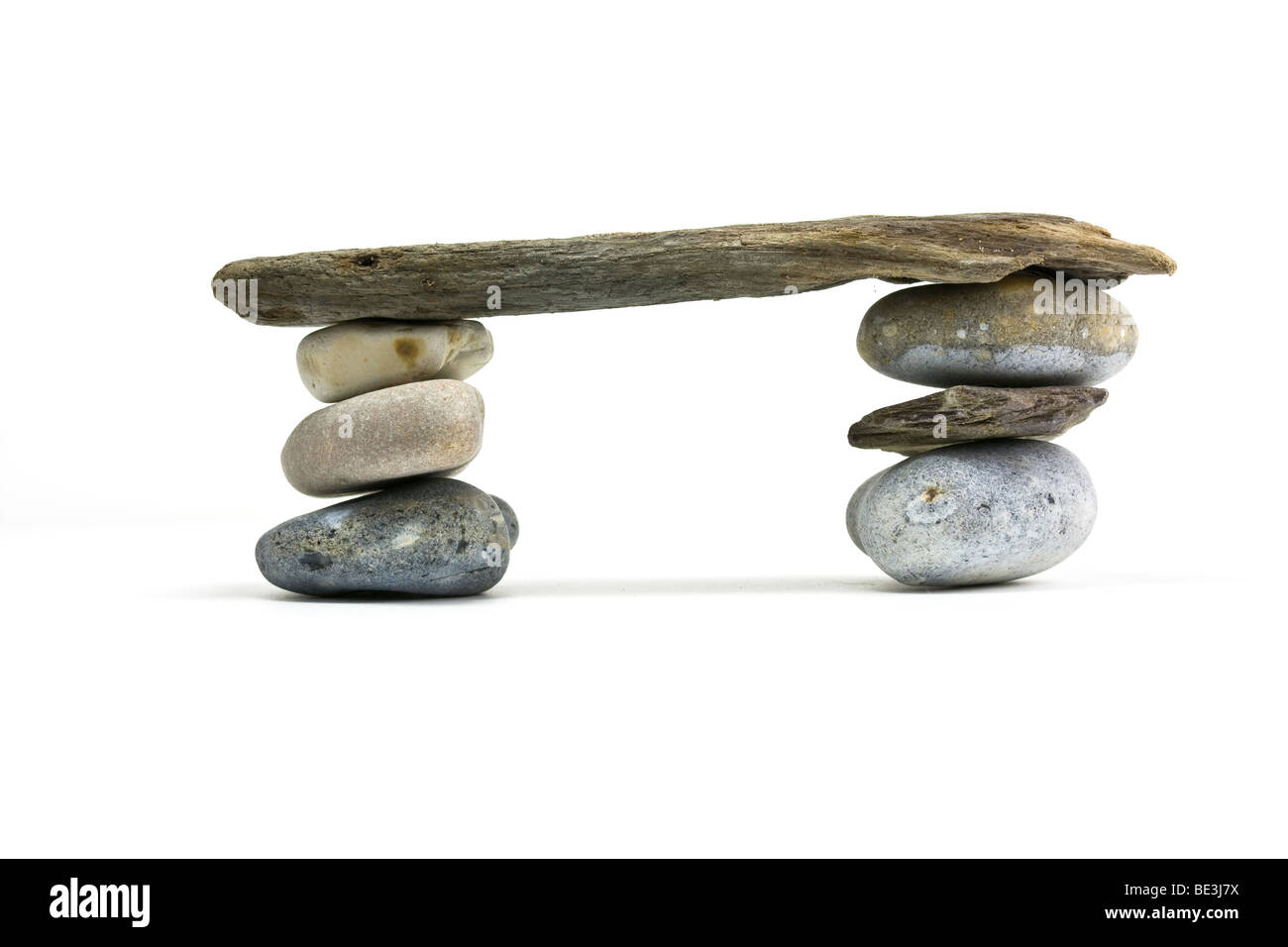 Carefully balanced tower of stones forming a bridge Stock Photo - Alamy