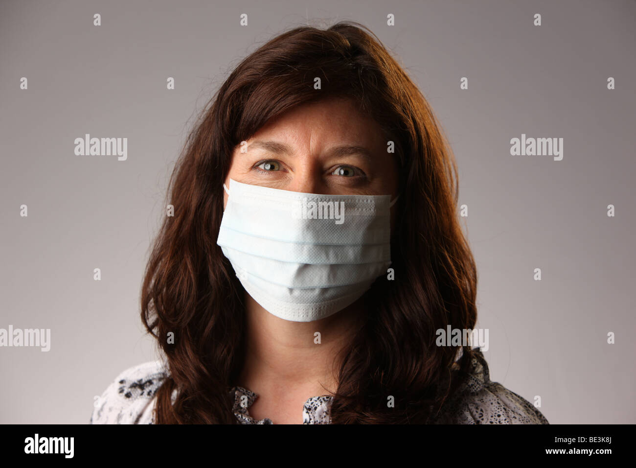 Woman wearing surgical mask to protect herself from contracting ...