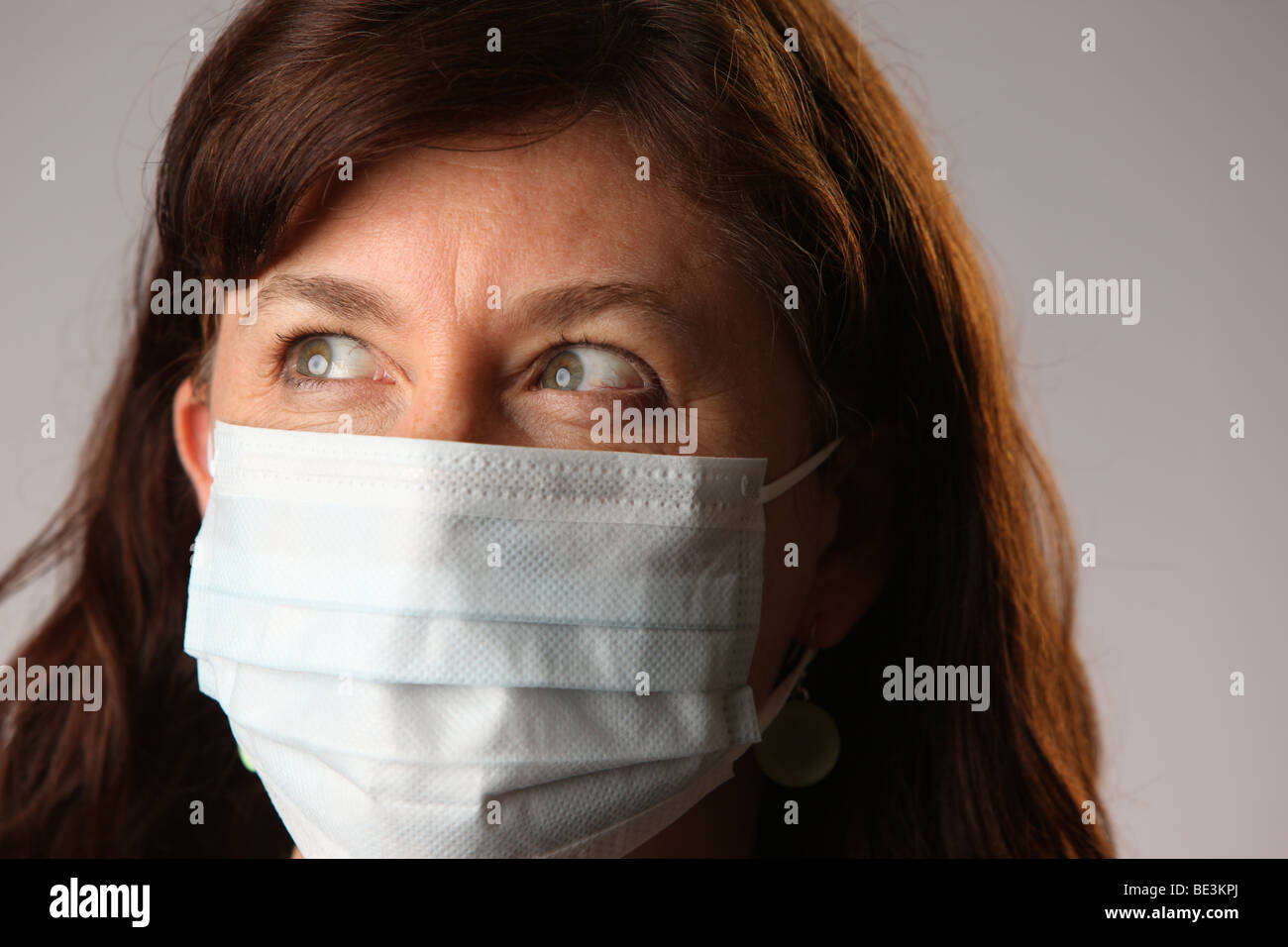 Woman wearing surgical mask to protect herself from contracting ...