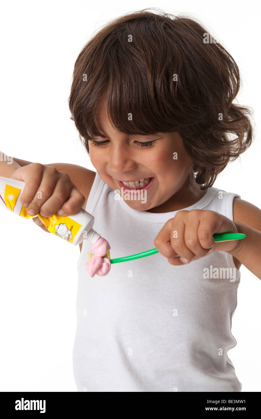 Little boy is putting a lot of toothpaste on his toothbrush Stock Photo ...
