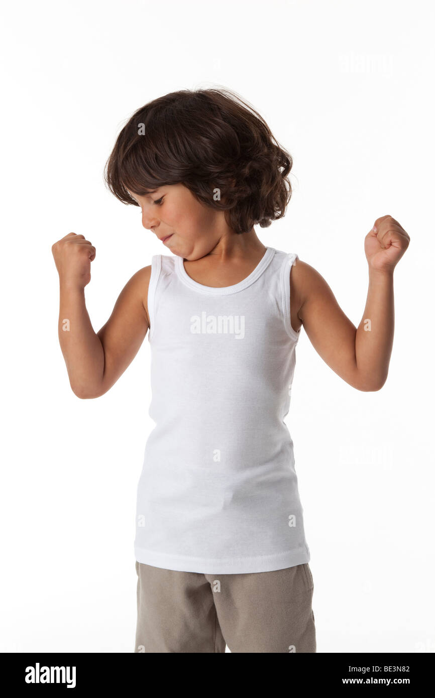 Little boy is looking at his arm muscles Stock Photo - Alamy