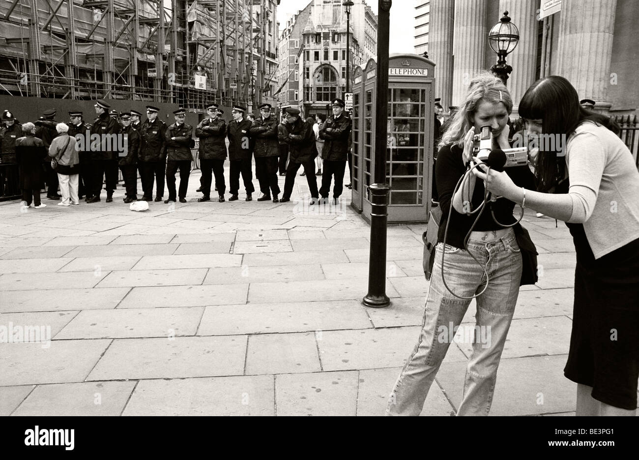 Two girls and riot police Stock Photo - Alamy