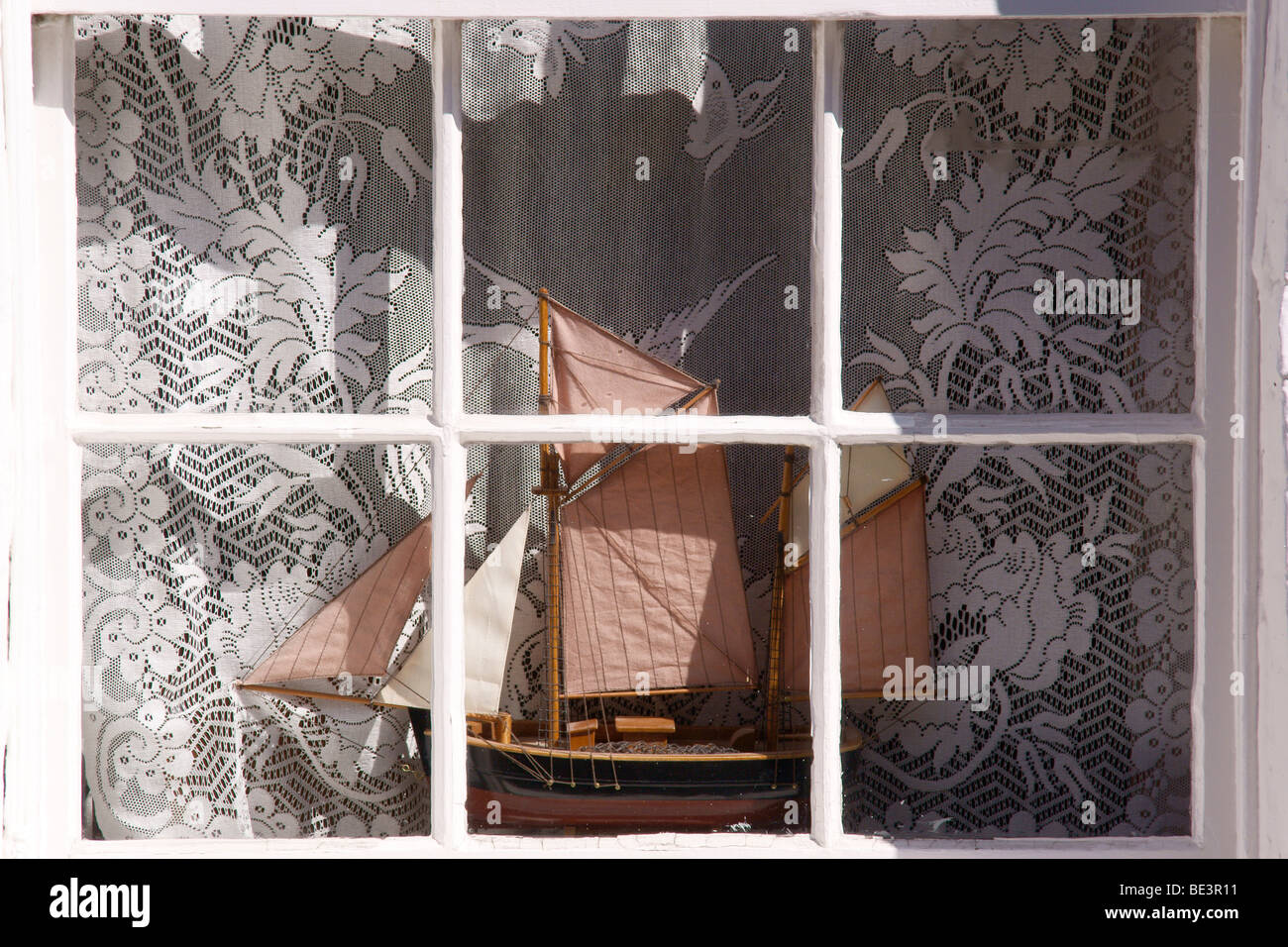 Model ship in a seaside window Stock Photo - Alamy