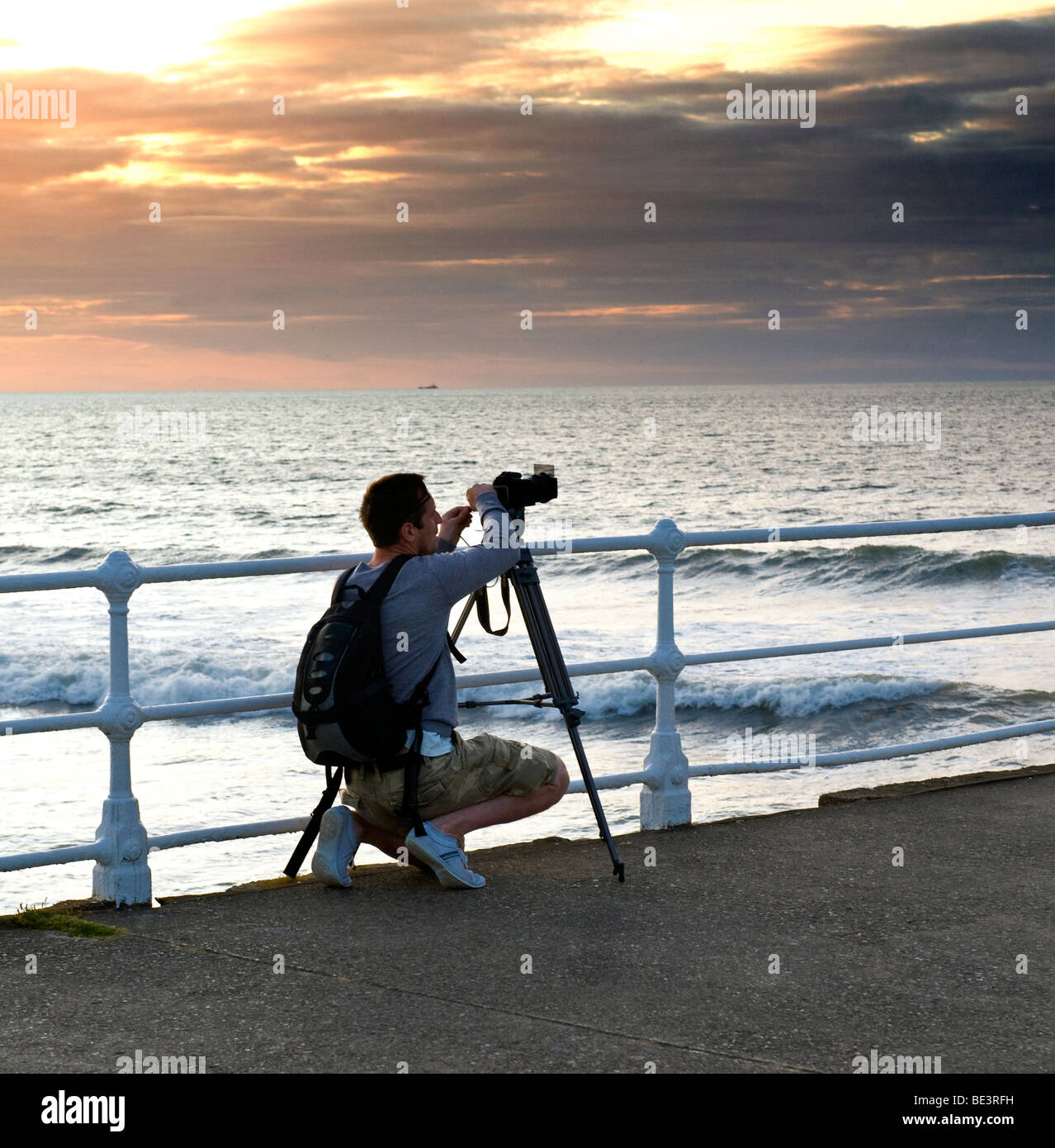 Man Taking Photograph Of Sunset Stock Photo - Alamy