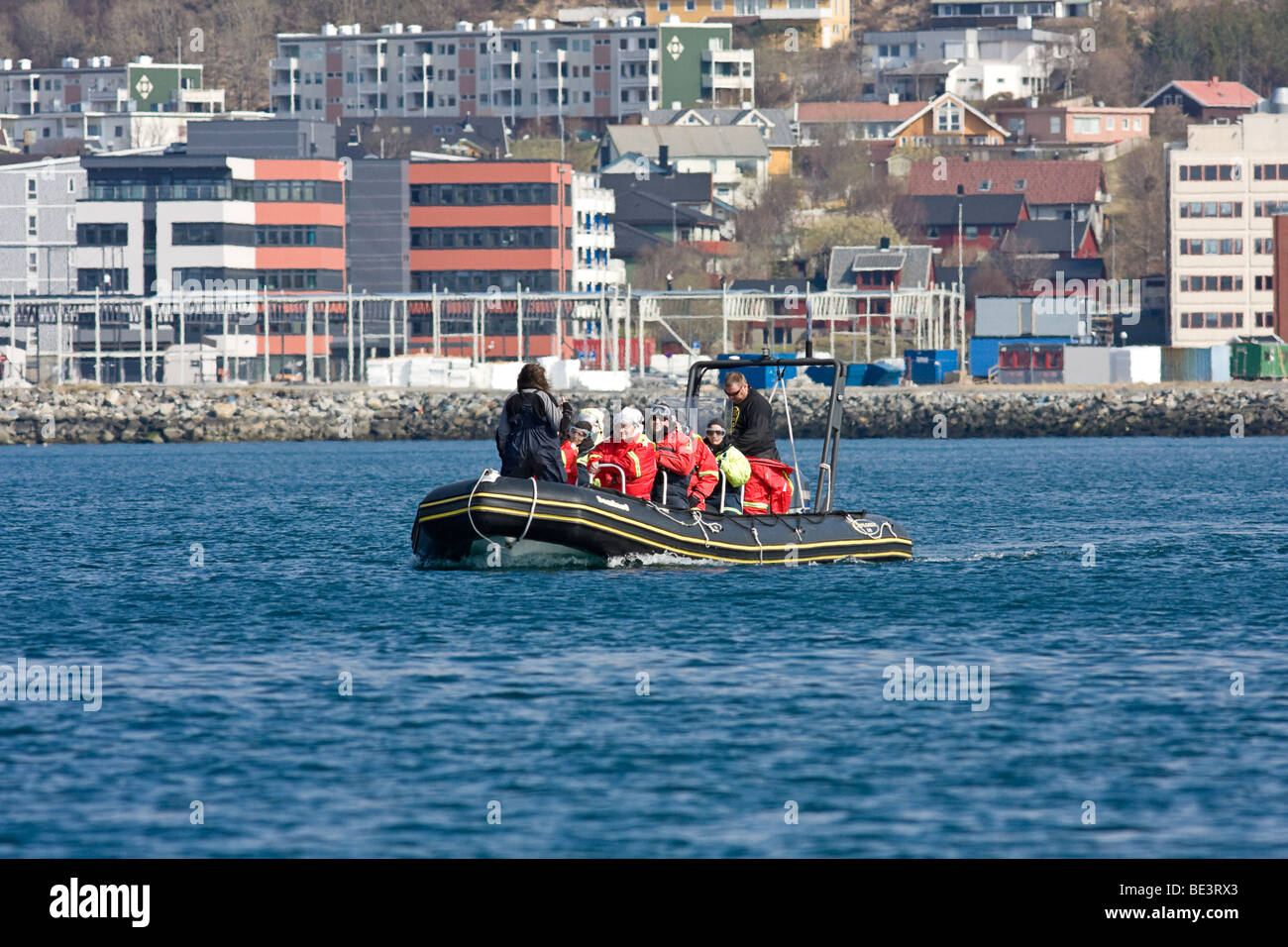 Tourists ride in a small rubber boat to see birds near the town of Bodo ...