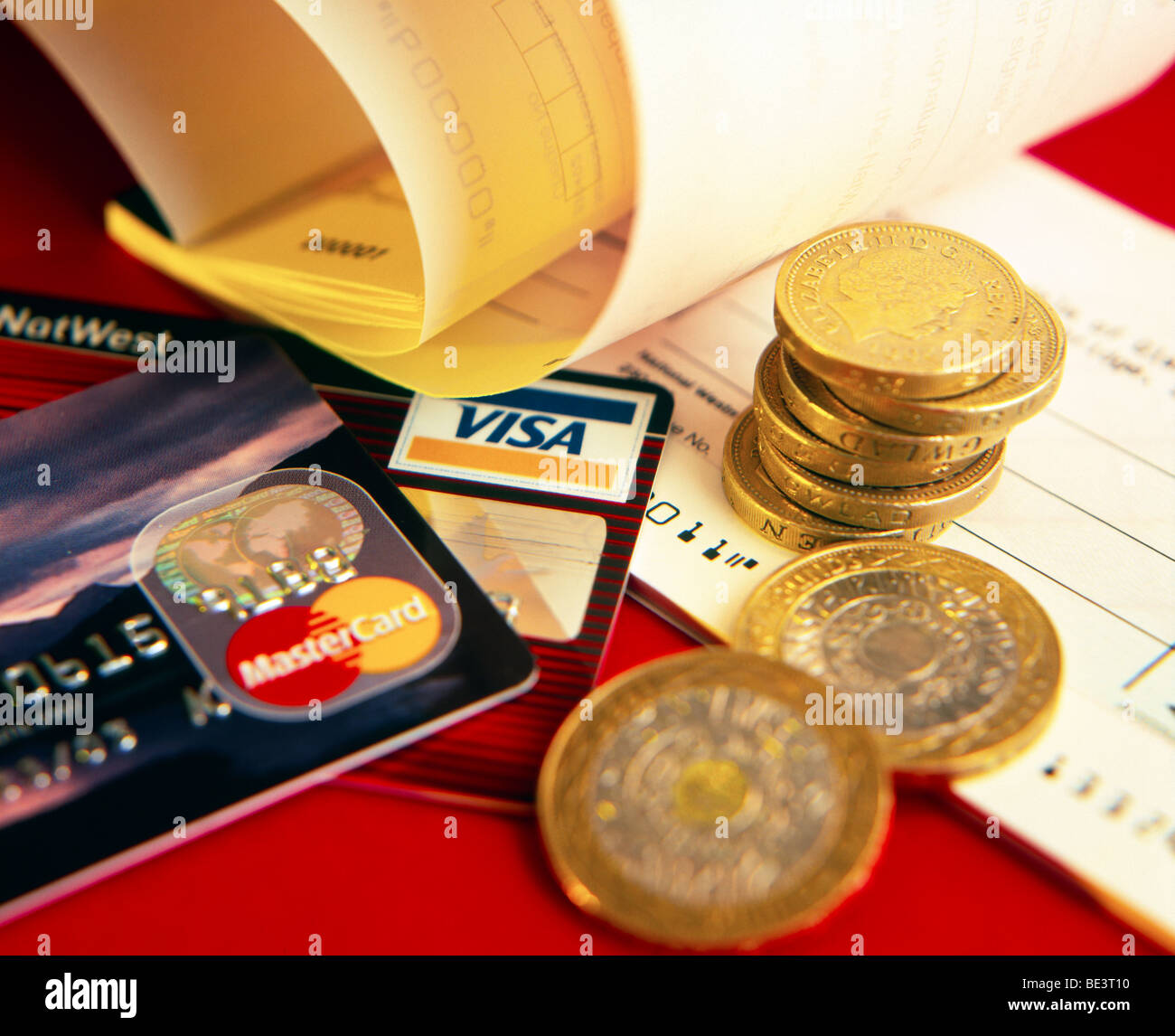 stack of UK coins with credit cards and a cheque book Stock Photo - Alamy