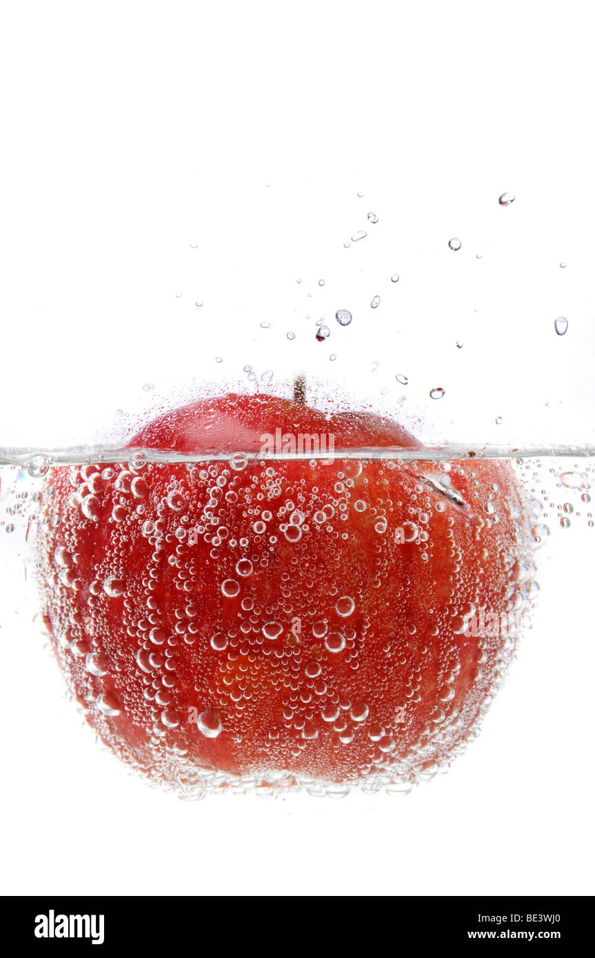 Apple in splashing water isolated on a white background Stock Photo - Alamy