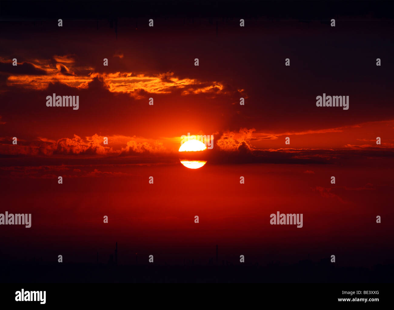 dramatic red sunrise on dark sky with clouds Stock Photo - Alamy