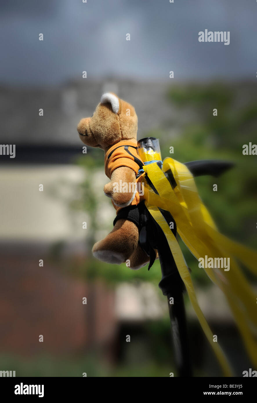 teddy bear with yellow ribbons streaming on end of black walking pole ...