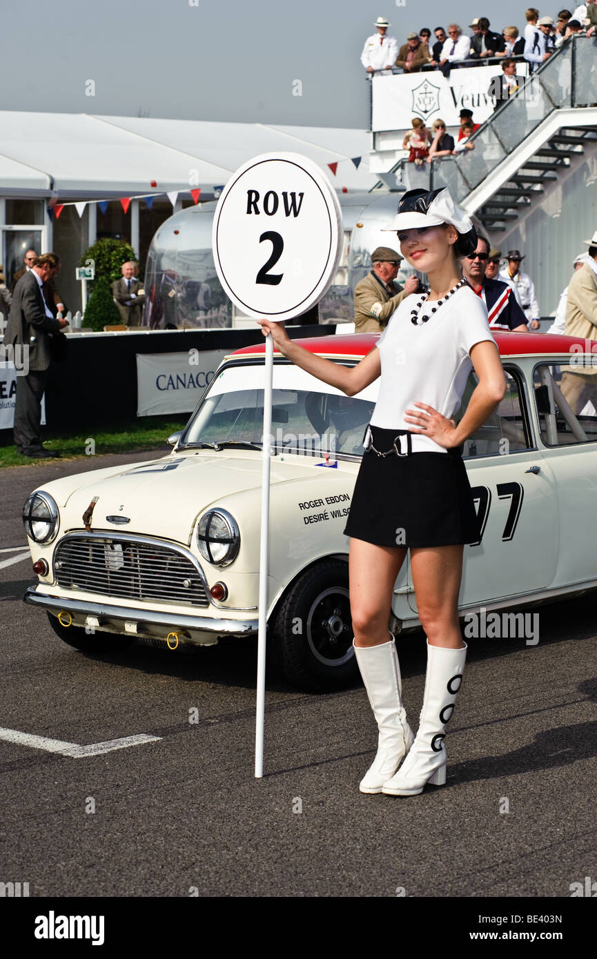 A Grid girl marking row 2 in front of a mini car on the grid for the ...
