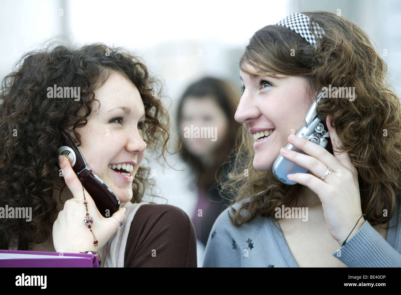 TWO YOUNG WOMEN WITH MOBILE PHONES Stock Photo - Alamy