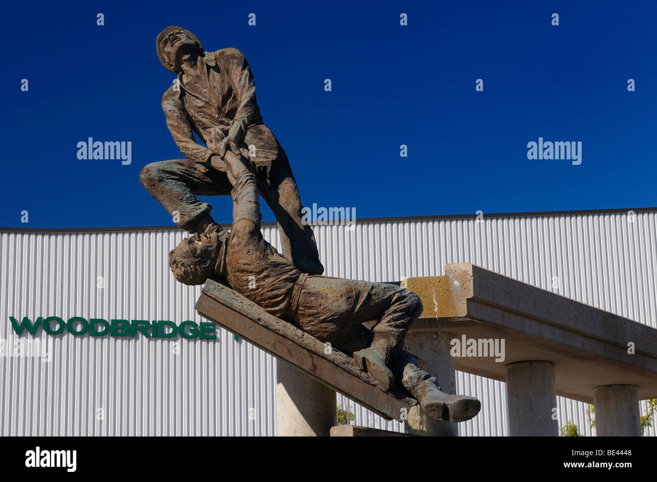 Sculpture of hero saving a construction worker with blue sky at ...