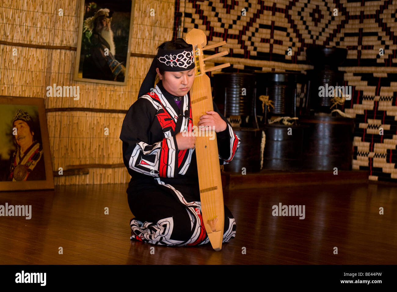 An Ainu woman plays a traditional stringed instrument - the Tonkori ...