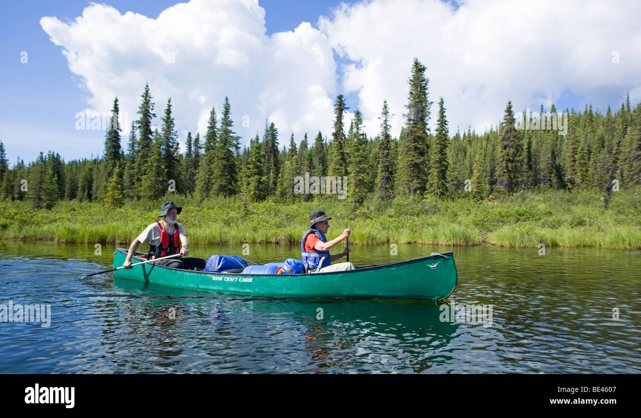 Couple, man and woman, canoeing, paddling, upper Liard River, Caribou ...