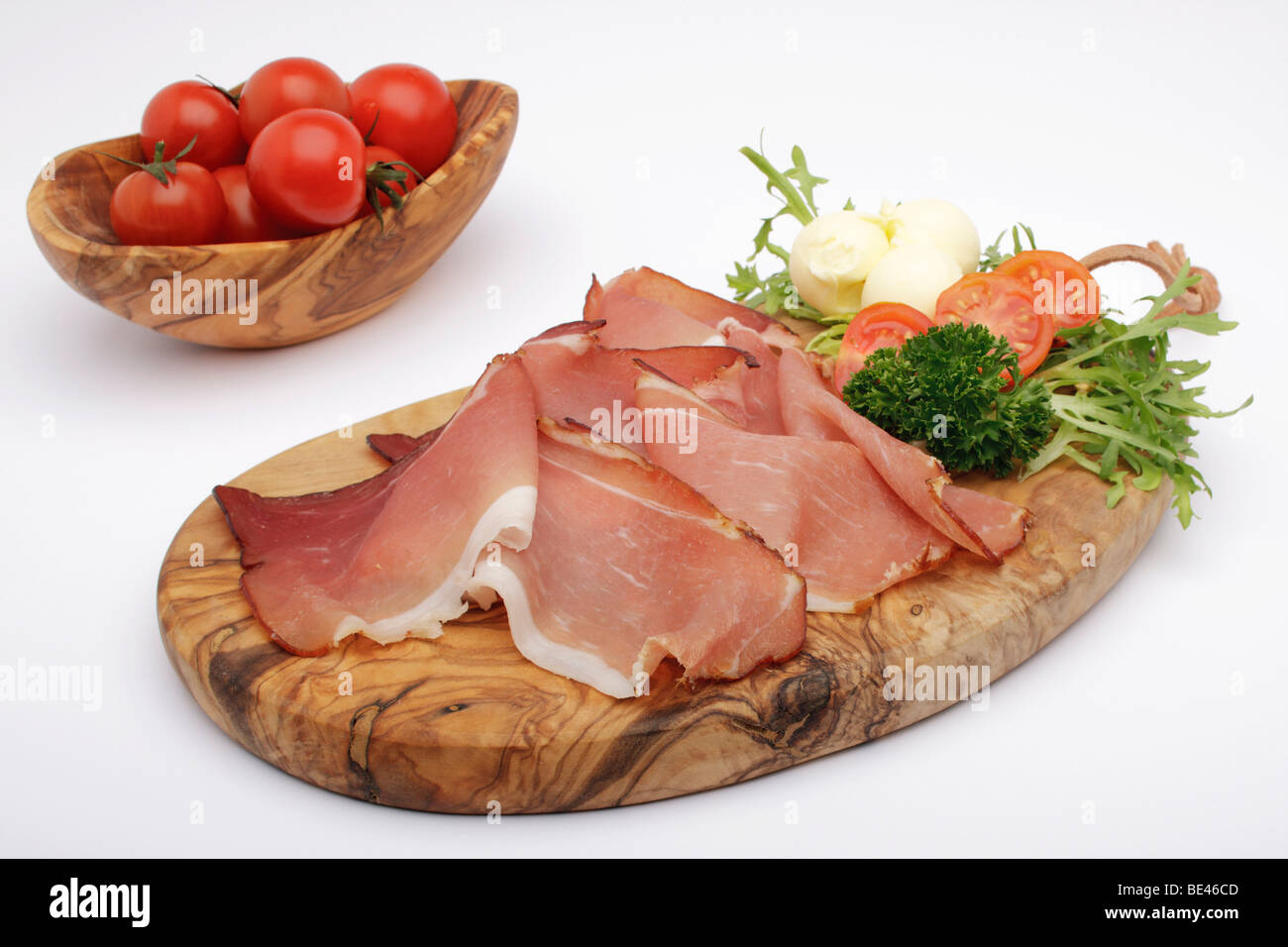 Raw ham with butter, cocktail tomatoes Stock Photo - Alamy