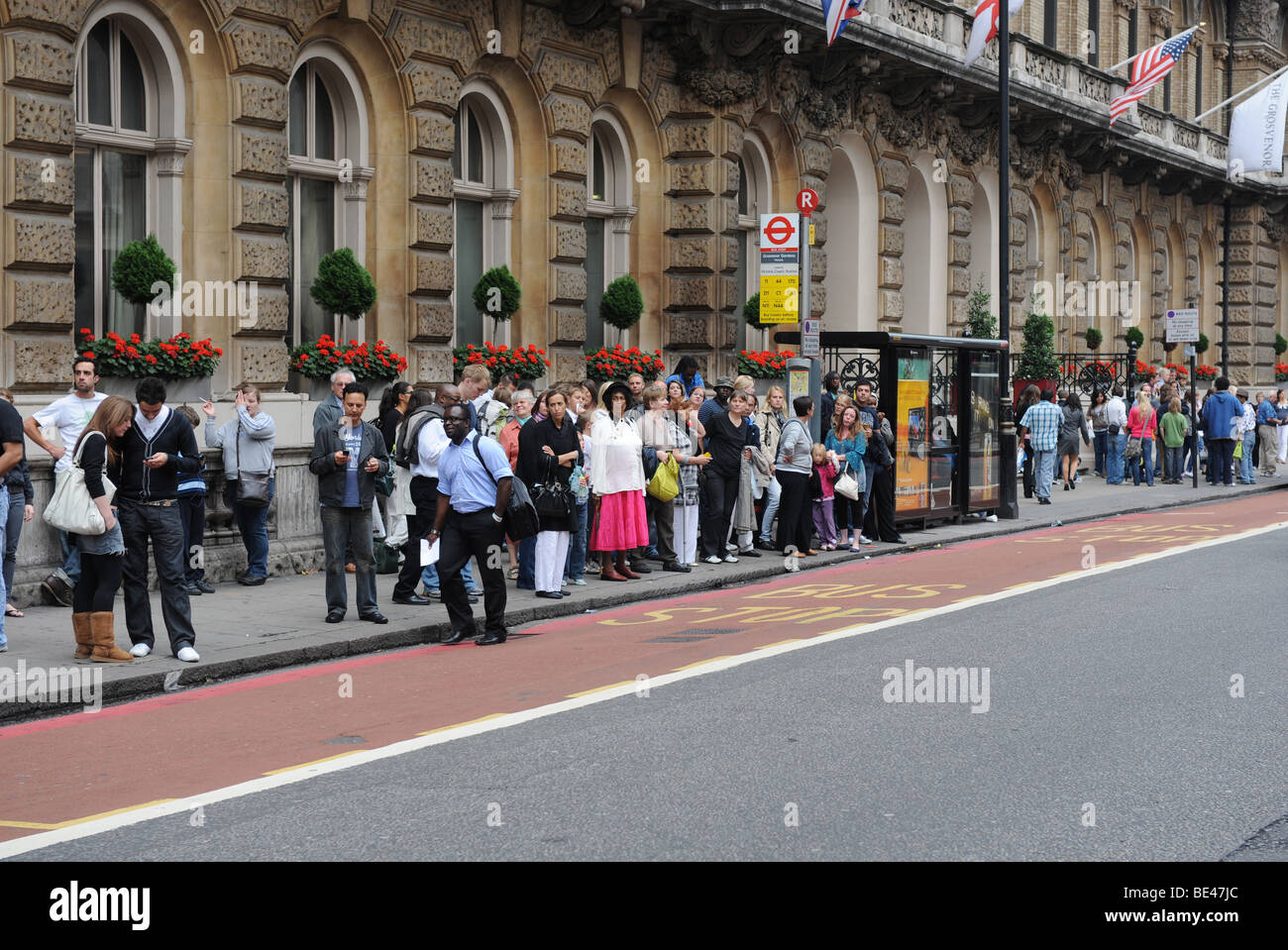 Line people queuing bus stop hi-res stock photography and images - Alamy