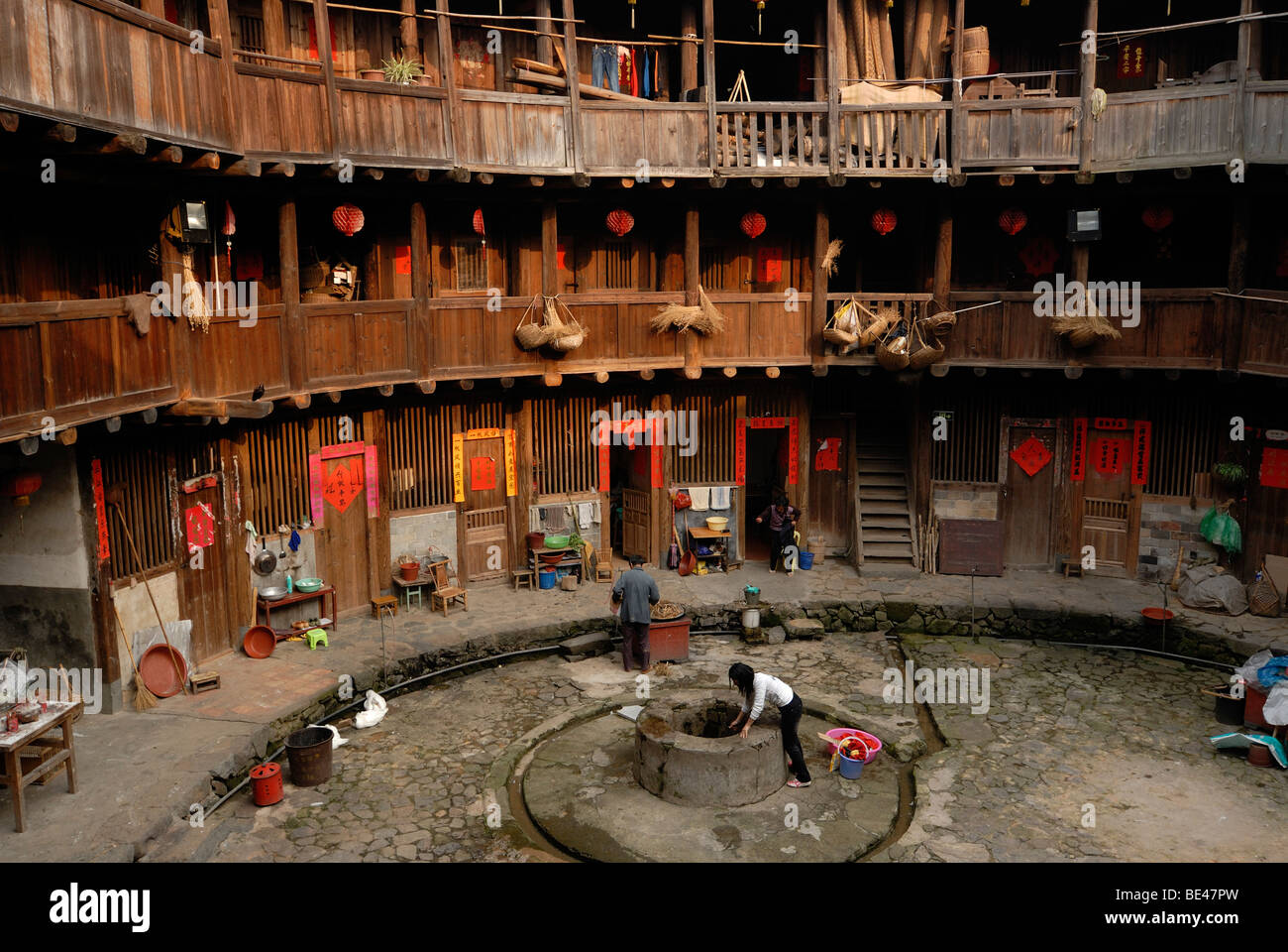 Courtyard with a fountain of a Tulou round house, dirt round houses ...