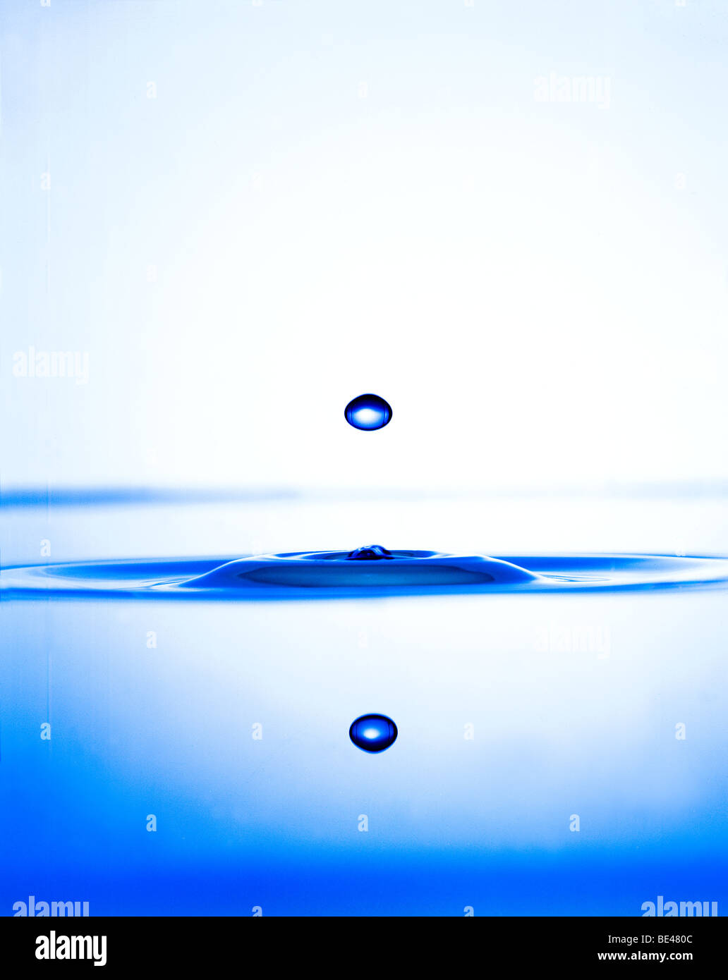 photograph of water drop breaking water surface Stock Photo - Alamy