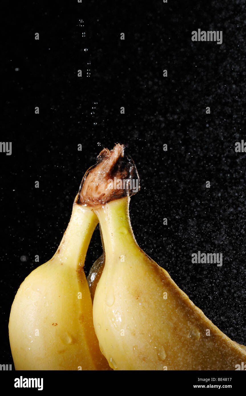 Rain over bananas. Black background Stock Photo - Alamy