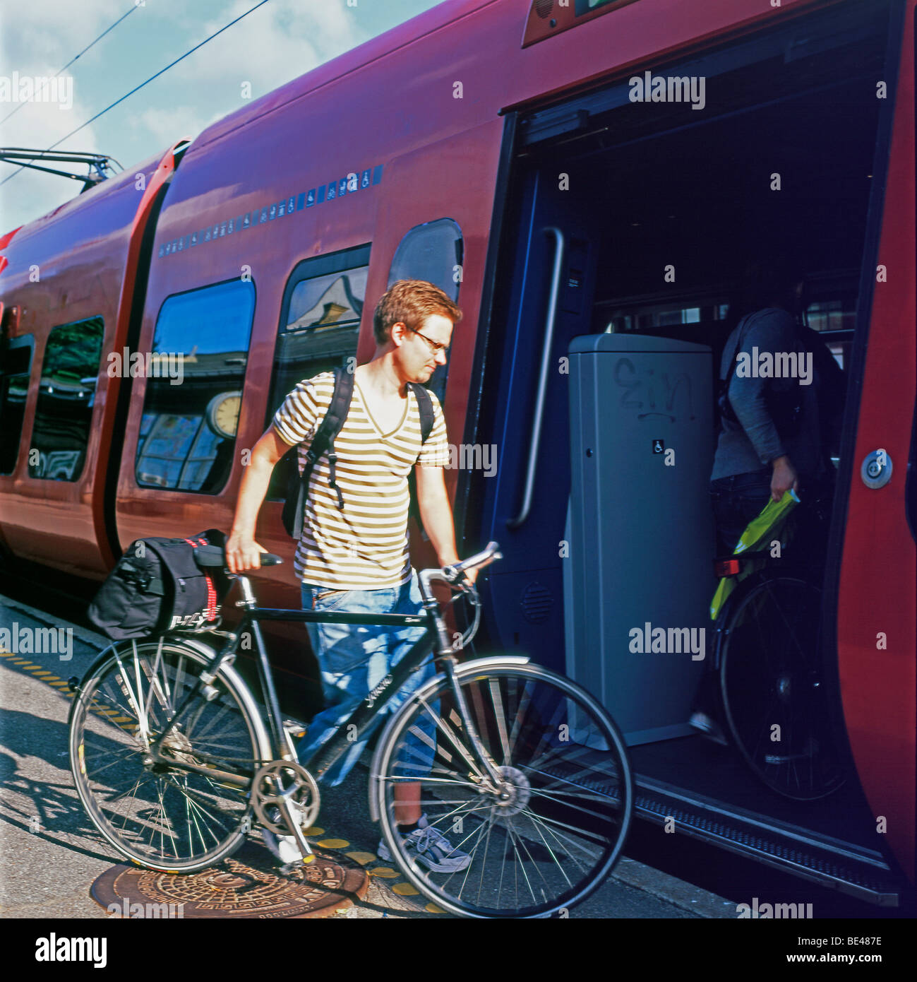 A man putting his bicycle on a train Copenhagen Denmark KATHY DEWITT ...