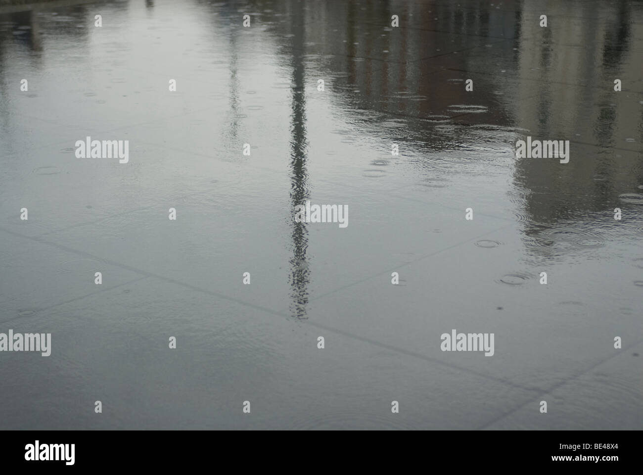 inverted reflection of buildings in a flooded pavement Stock Photo - Alamy